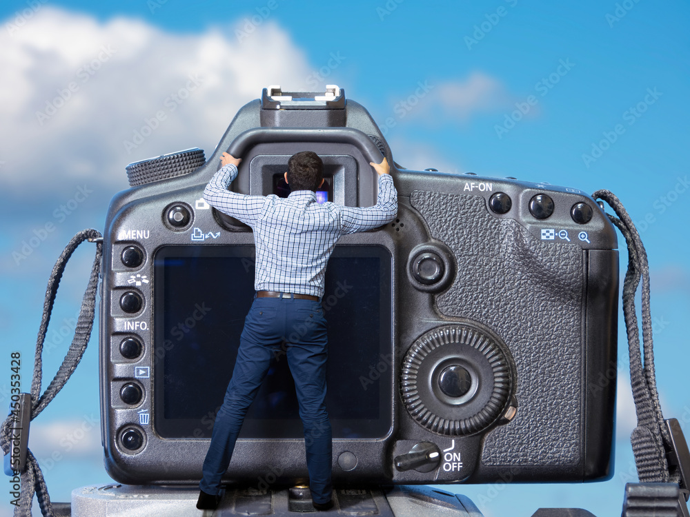 Giant camera and small photographer. Surreal concept Stock Photo ...