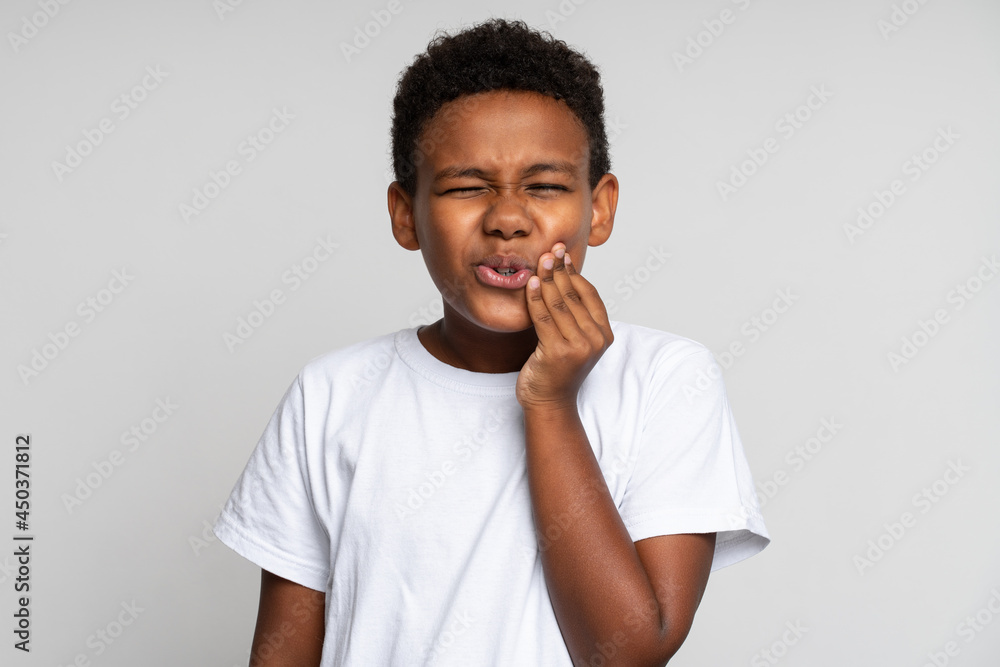Dental pain in children. Portrait of unhealthy little boy touching ...