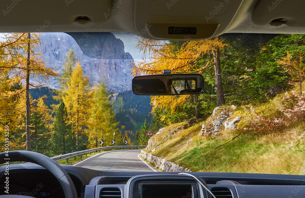 view on the Alps through the windscreen of the car while driving on the ...