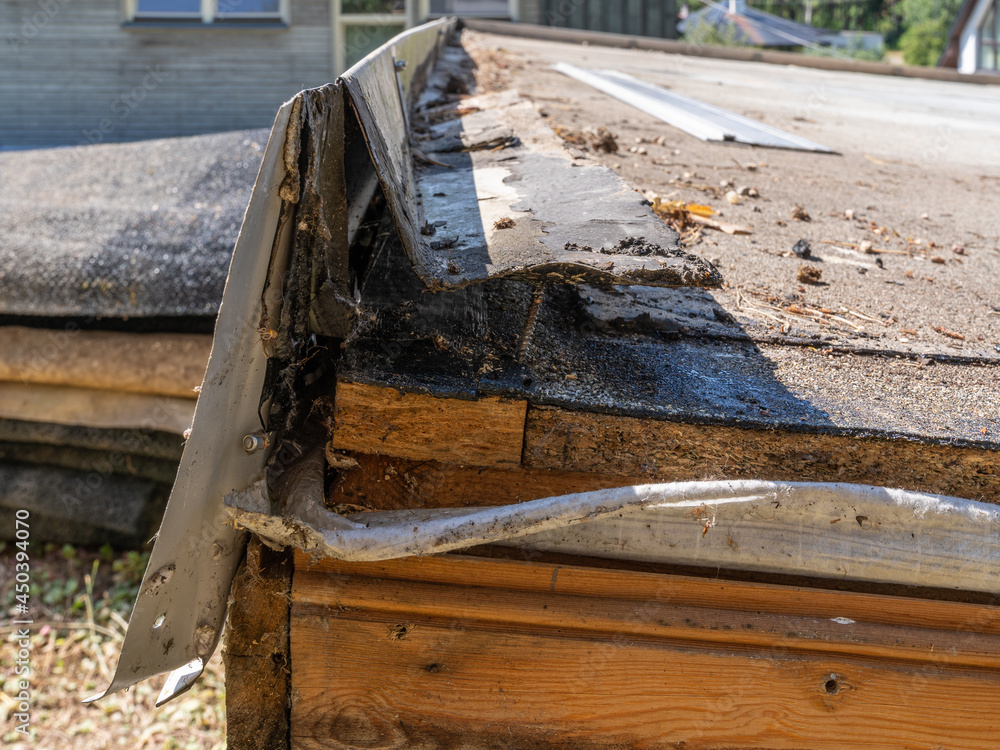 damaged flat roof edge, showing roof rafters, osb plate, waterproofing ...