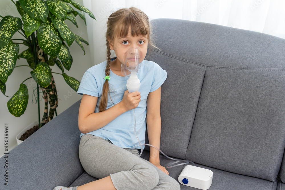 Little girl making inhalation with nebulizer at home. child asthma ...