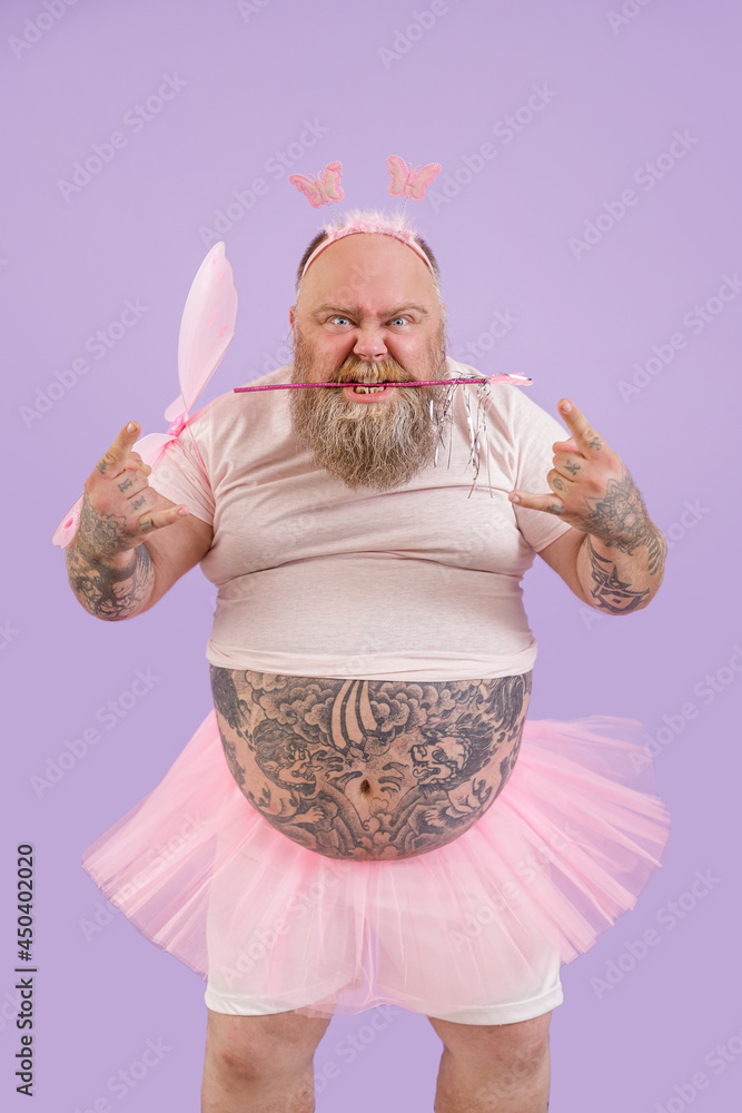 Brutal person with overweight and tattoos in fairy suit with wings ...