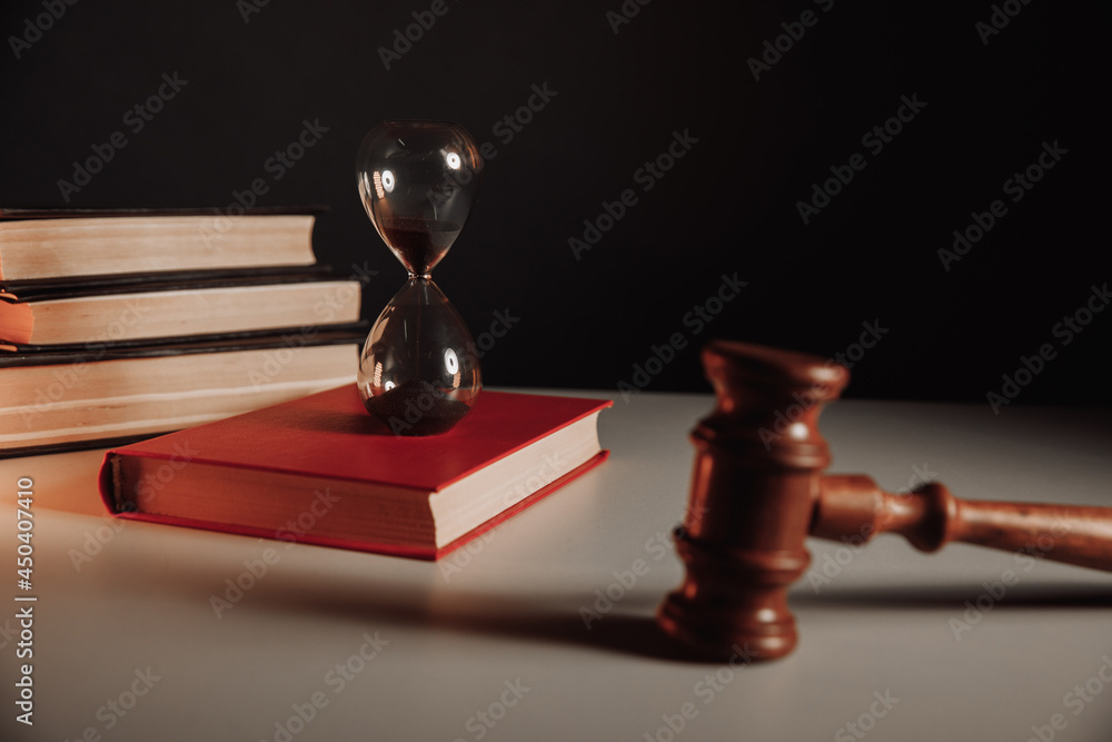 Law code. Hourglass with red book and judge gavel Stock Photo | Adobe Stock