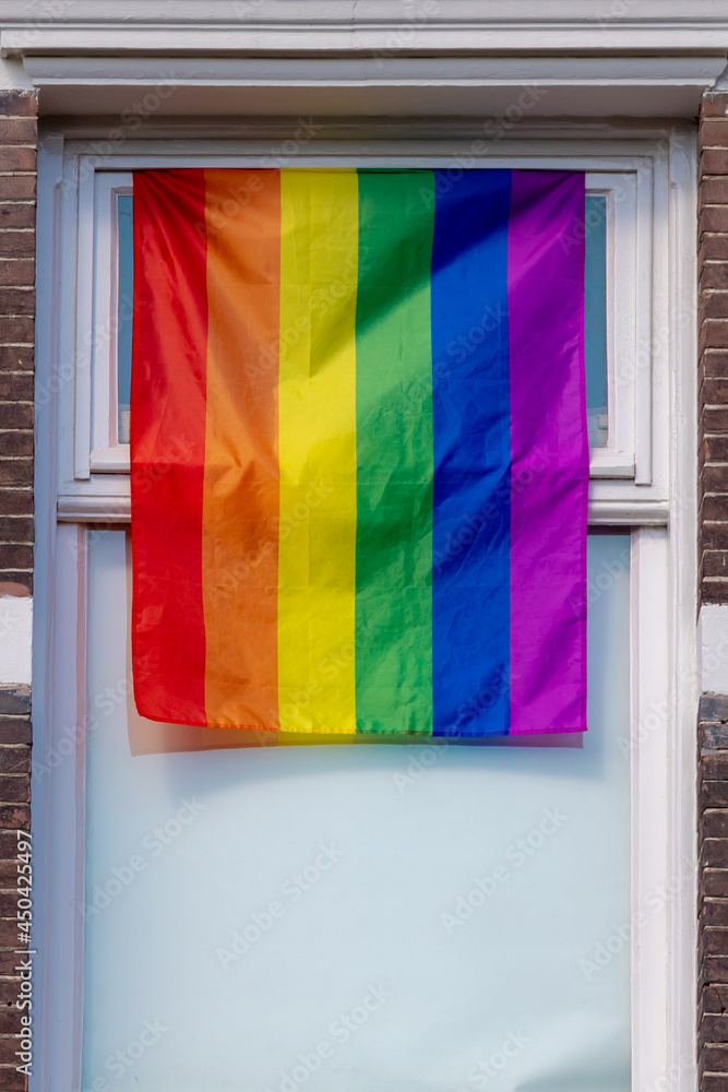 Celebration of Pride month, Colourful rainbow flag hanging outside the ...