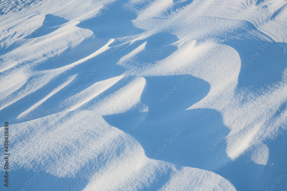 Snow texture. Wind sculpted patterns on snow surface. Wind in the ...
