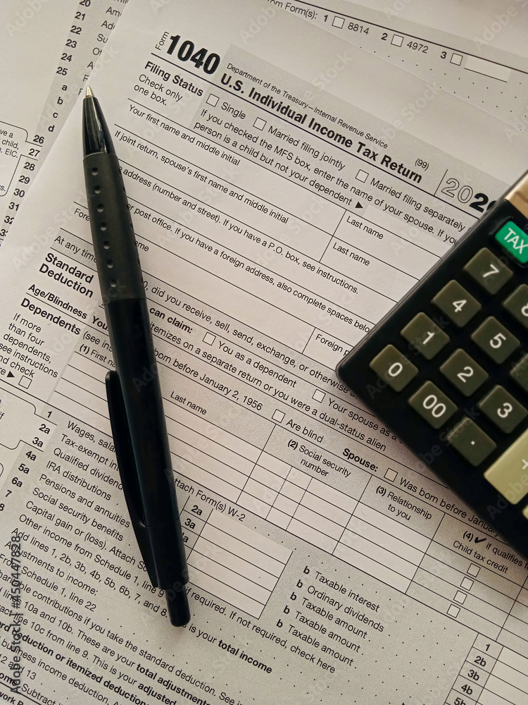 1040 US Individual Income Tax Return Form with black color pen and ...