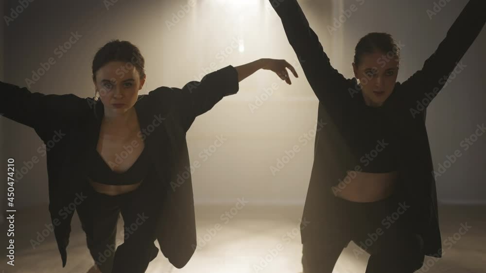 Front view of two confident concentrated Caucasian female dancers ...