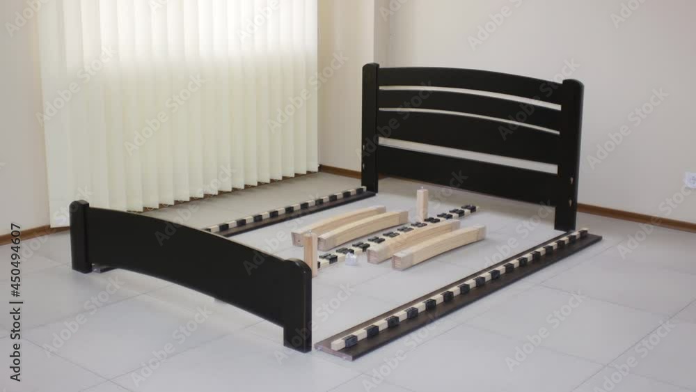 mounting of the frame of an orthopedic double wooden bed with a rigid ...