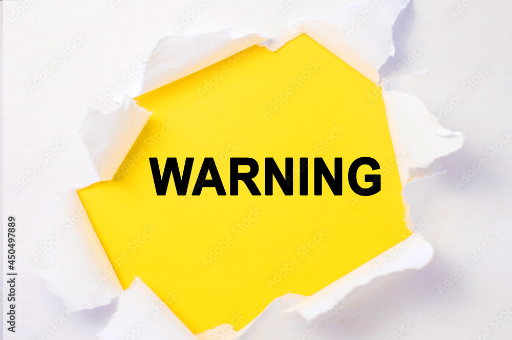 The word warning is written on a yellow background that is in the ...