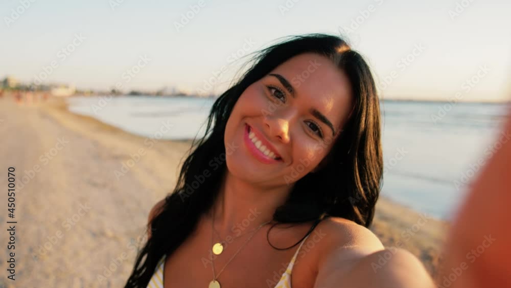 people, summer and swimwear concept - happy smiling young woman in ...