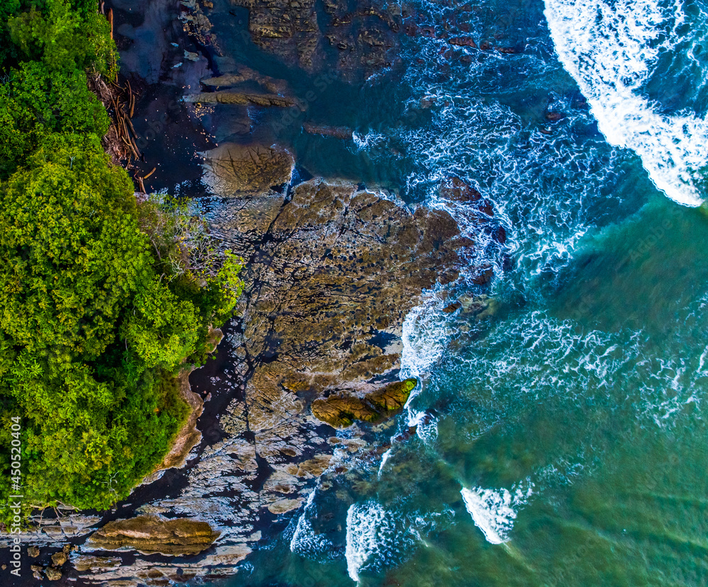 Overhead top down drone shot of rocks and waves, cliff side and ...
