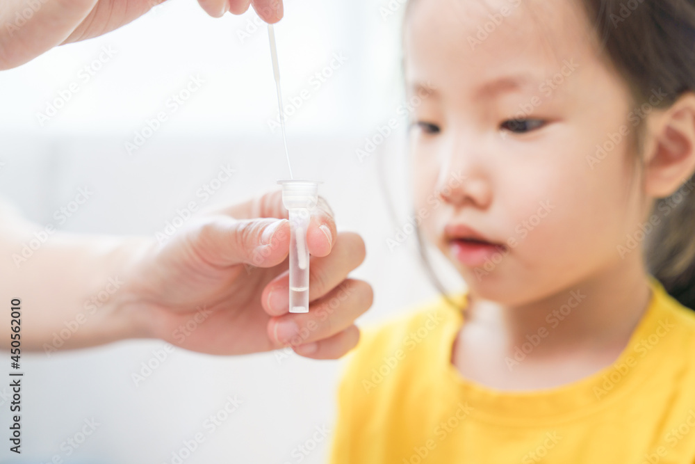 Adorable Asian girl kid pay attention with swab test process by her ...