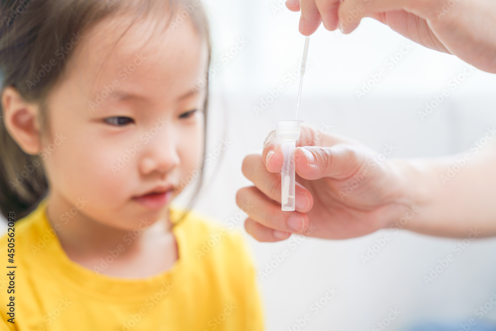 Adorable Asian girl kid pay attention with swab test process by her ...