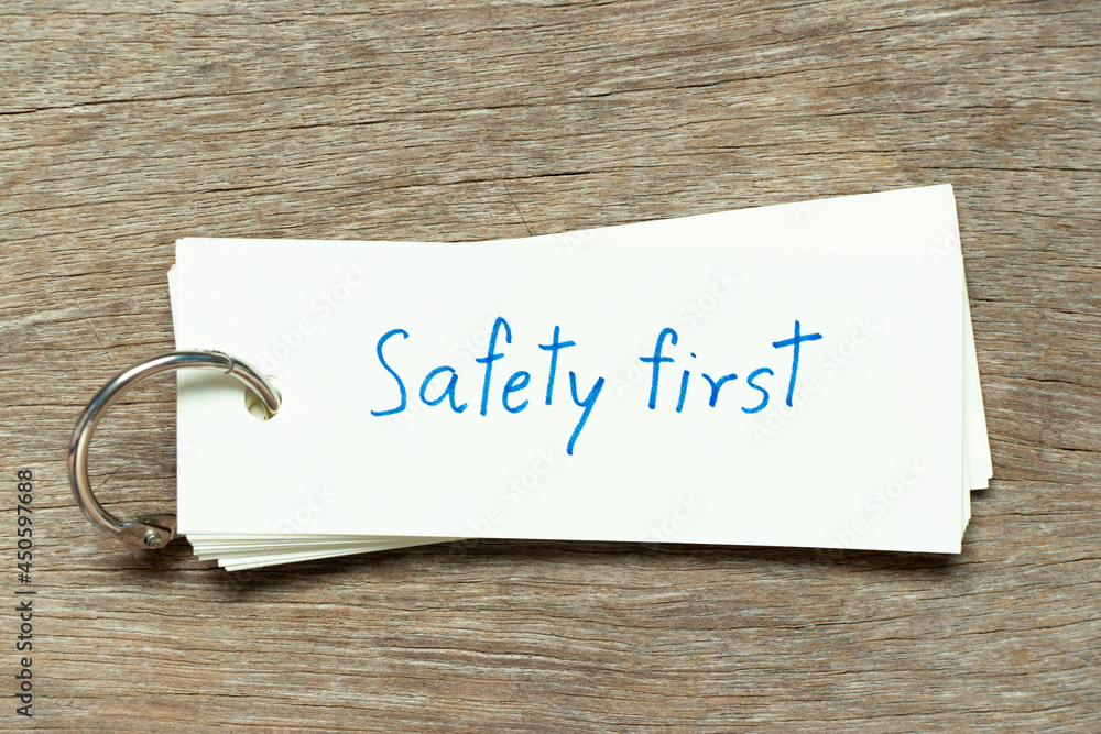 Flash card with handwriting word safety first on wood background Stock ...