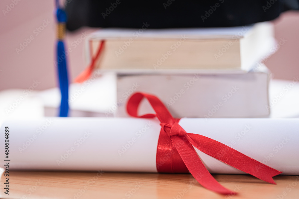 Cropped photo of a university graduation hat mortarboard and diploma ...