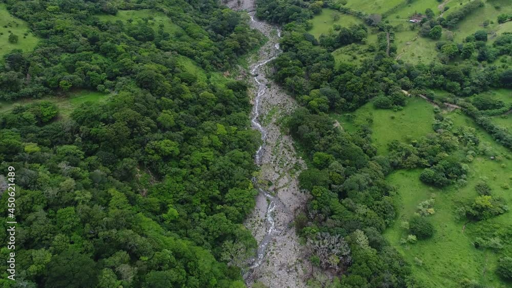 Aerial pans up on remote mountain river valley in highlands of Costa ...