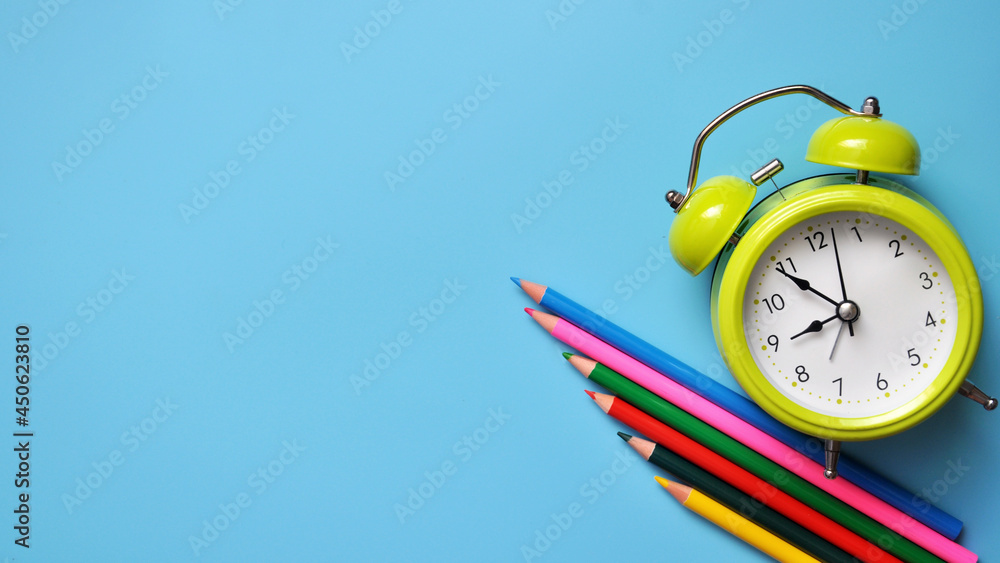 Bright school background with pencils and an alarm clock Stock Photo ...