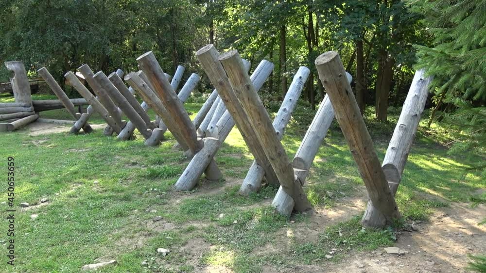 Wood round timber hammered into the ground in adventure park for ...