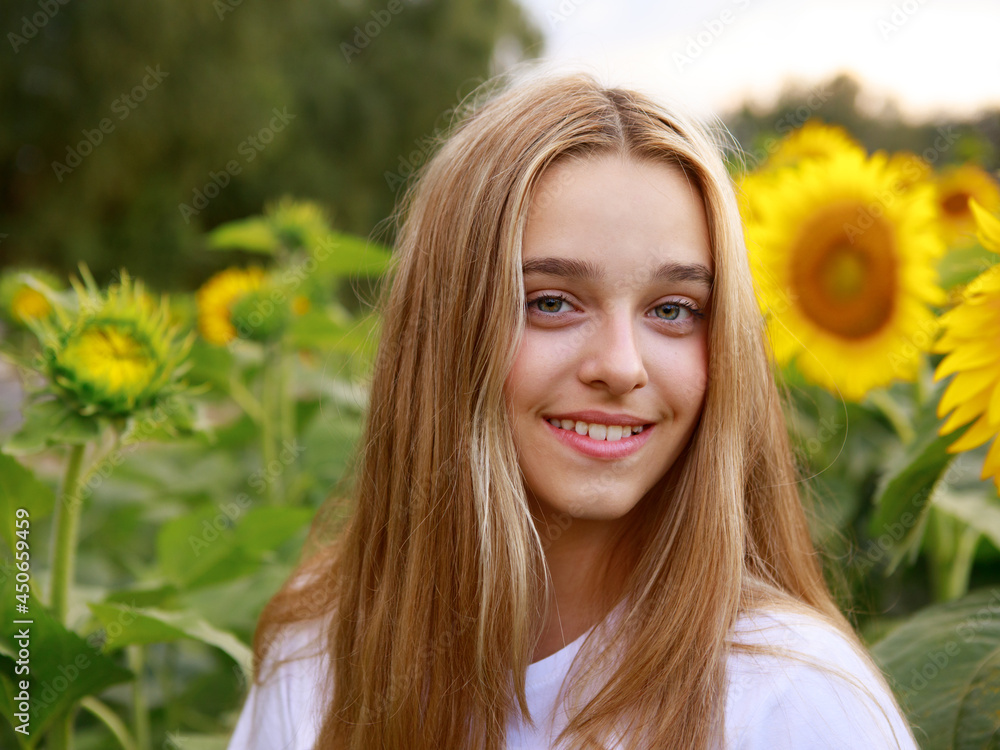 12 year old girl on a field of sunflowers Stock Photo | Adobe Stock