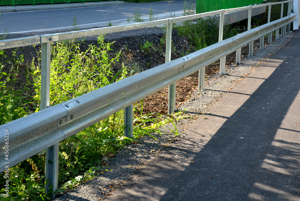 path for cyclists with an asphalt surface. galvanized iron railing over ...