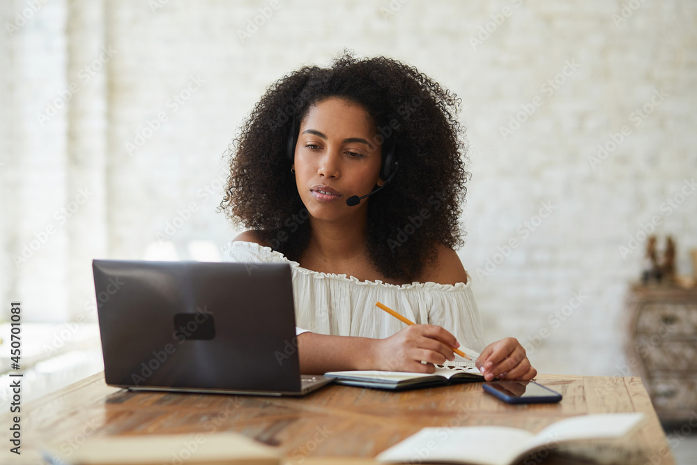 Young black woman studying online using laptop and video call with ...