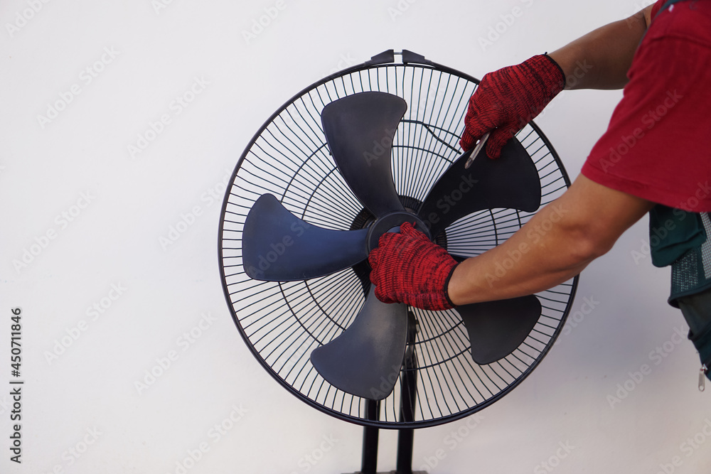 Mechanic is fixing and combining fan blade of electric fan. Concept ...