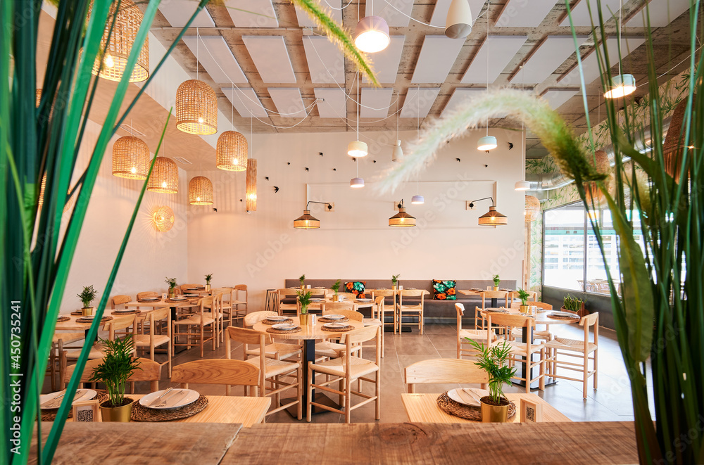 empty rustic design restaurant with wooden furniture seen from a ...