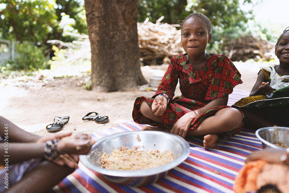Fotka „Pretty little black girl sitting crossed legs on a mat ...