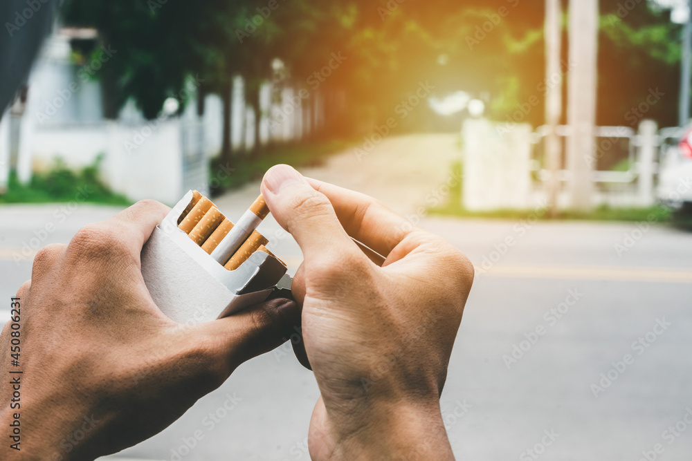 Close up man hand holding peel it off cigarette pack prepare smoking a ...