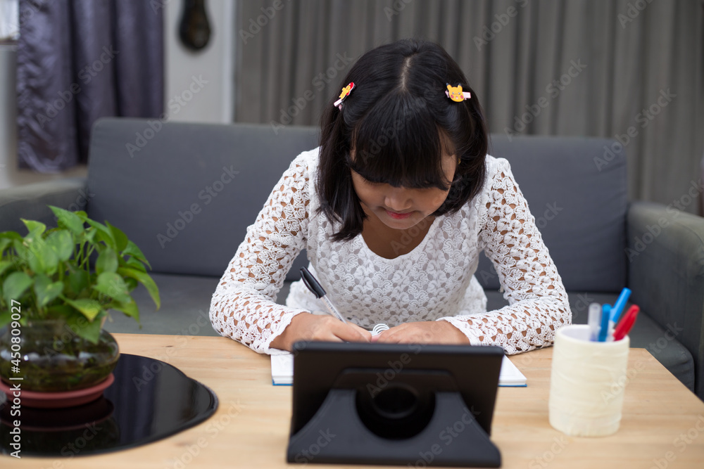 10 years old southeast asian child learning distantly from home. Online ...