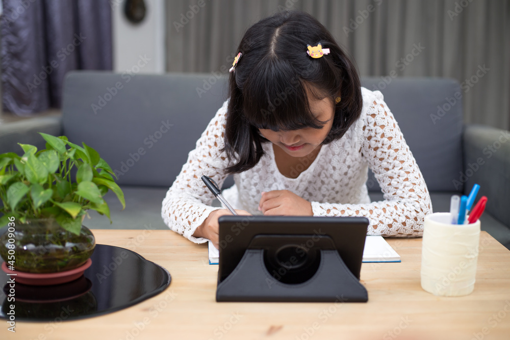 10 years old southeast asian child learning distantly from home. Online ...