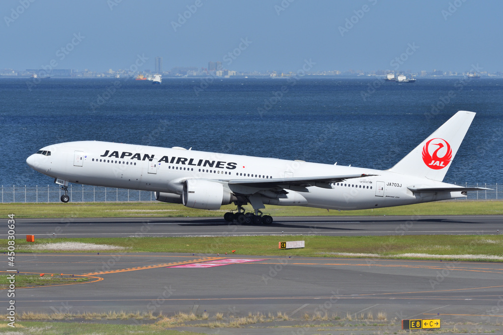 Tokyo, Japan - April 18, 2021:Japan Airlines (JAL) Boeing B777-200ER (JA703J) passenger plane ...