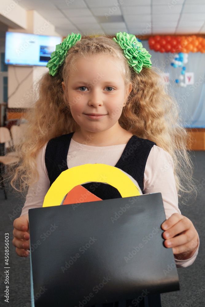 girl in a uniform . pupil, learner, scholar.book Stock Photo | Adobe Stock