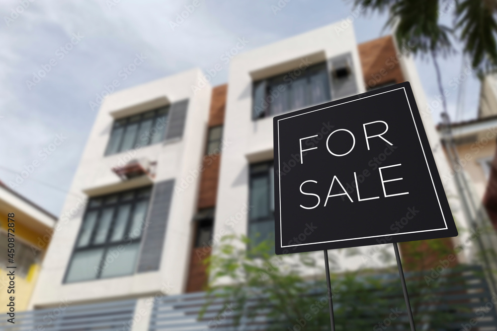 For sale sign in front of an affordable three storey apartment building ...