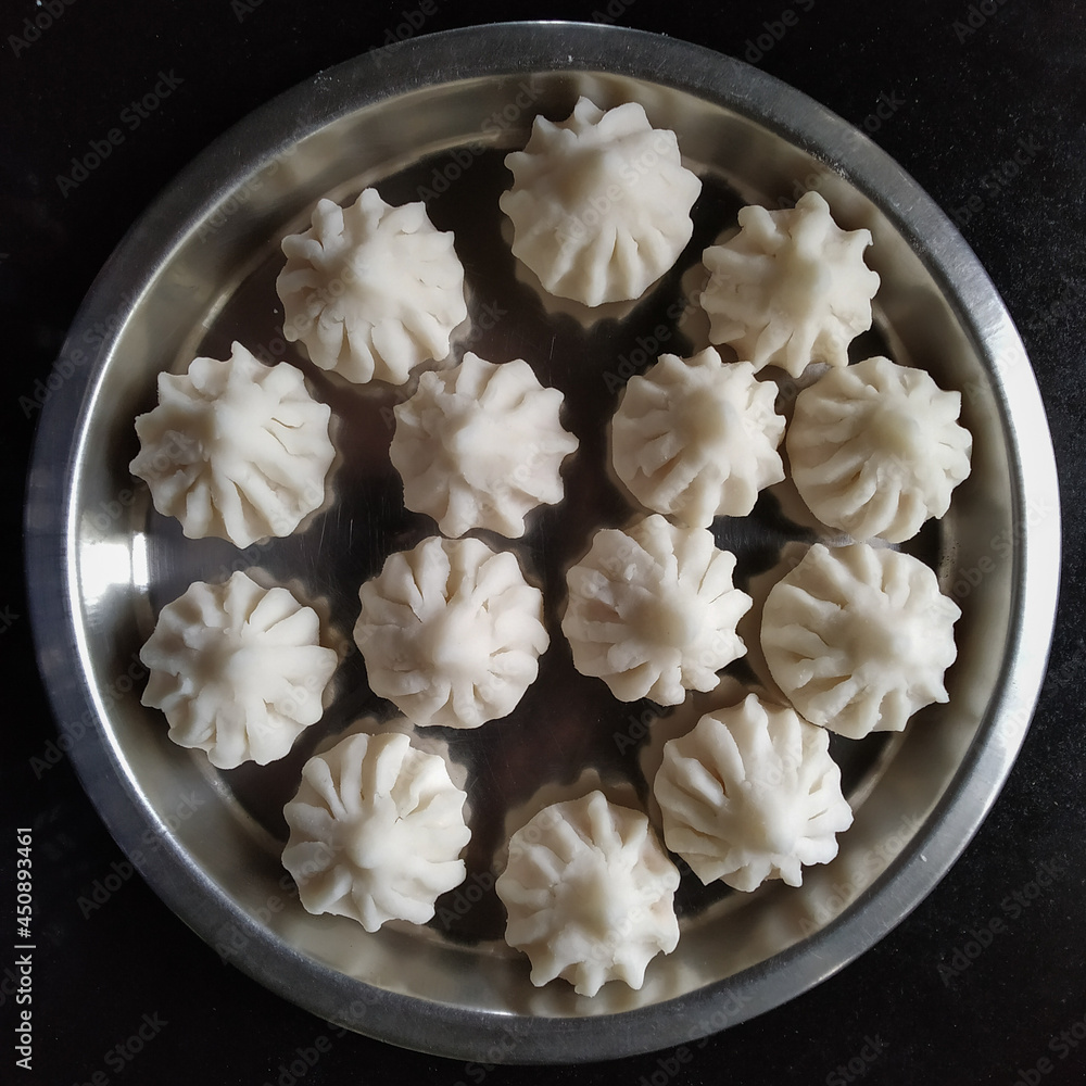 Modak, Maharashtrian traditional food, serve in steel plate Stock Photo ...