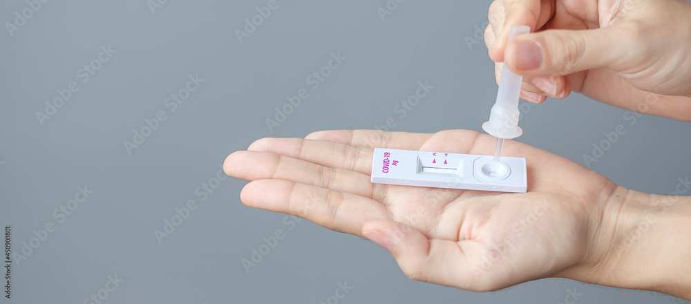 man swab COVID-19 testing by Rapid Antigen Test kit. Coronavirus Self ...