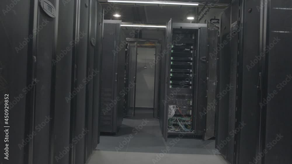 Camera moves through big working data center with server racks . Real ...