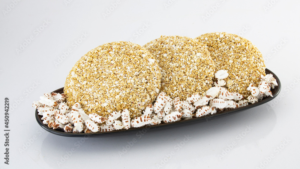 A dish of parched rice cake, (khoi er chatur naru). prepare by popped ...