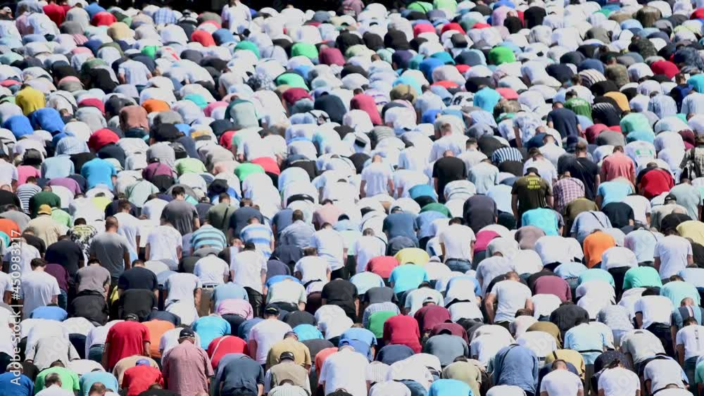 Muslim worshipers praying. Large crowd of Muslim people praying namaz. Muslims praying. Bosnians ...