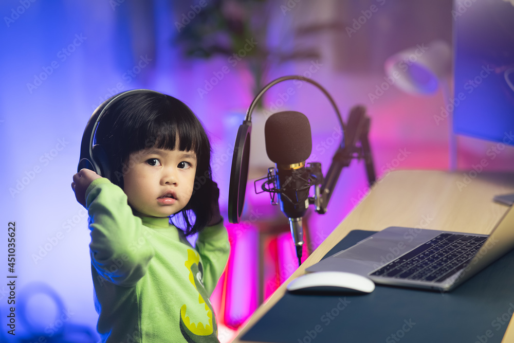cute baby girl singing with headphone recording new song with ...