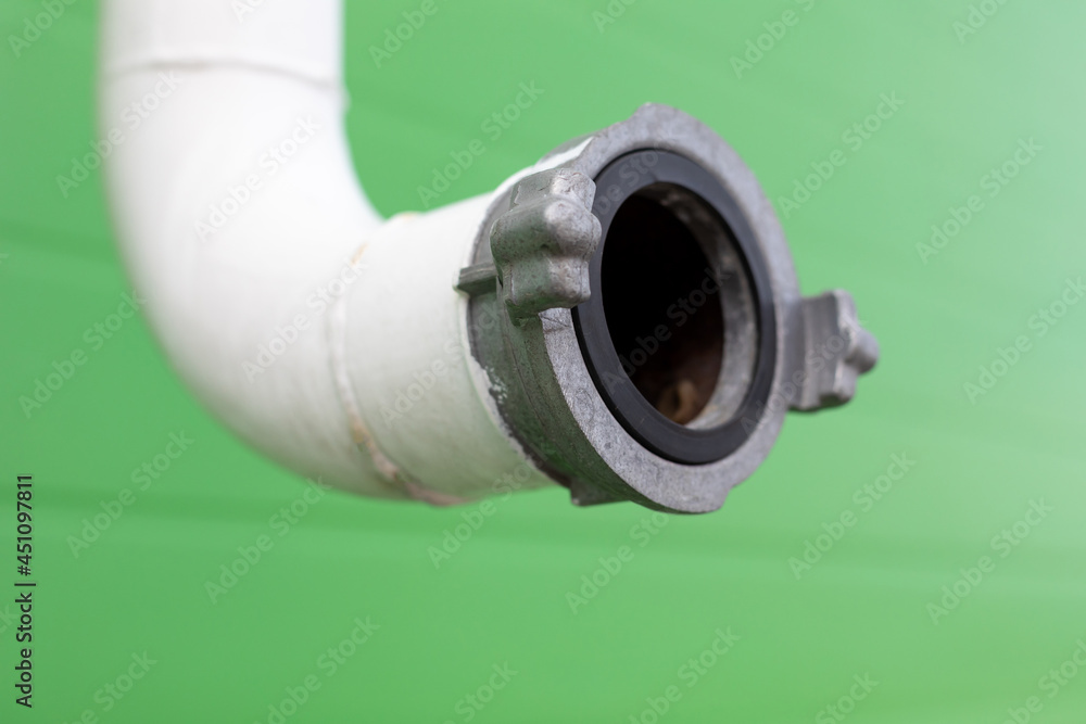 Socket for connecting fire hose near the green wall of an industrial ...