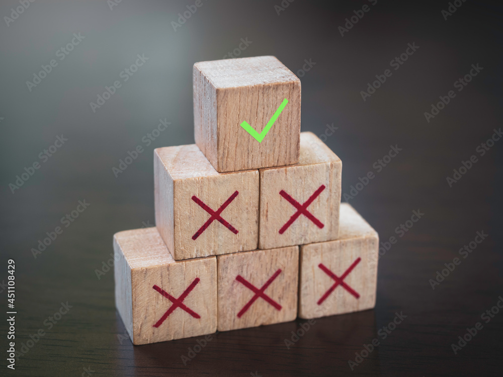 Green check mark icon on top of red cross icons on wooden cube blocks ...