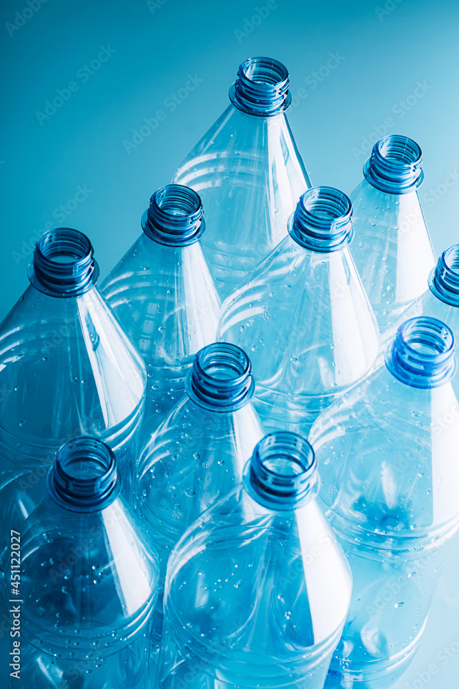 Empty plastic bottles on a blue background. Recycling recyclable ...