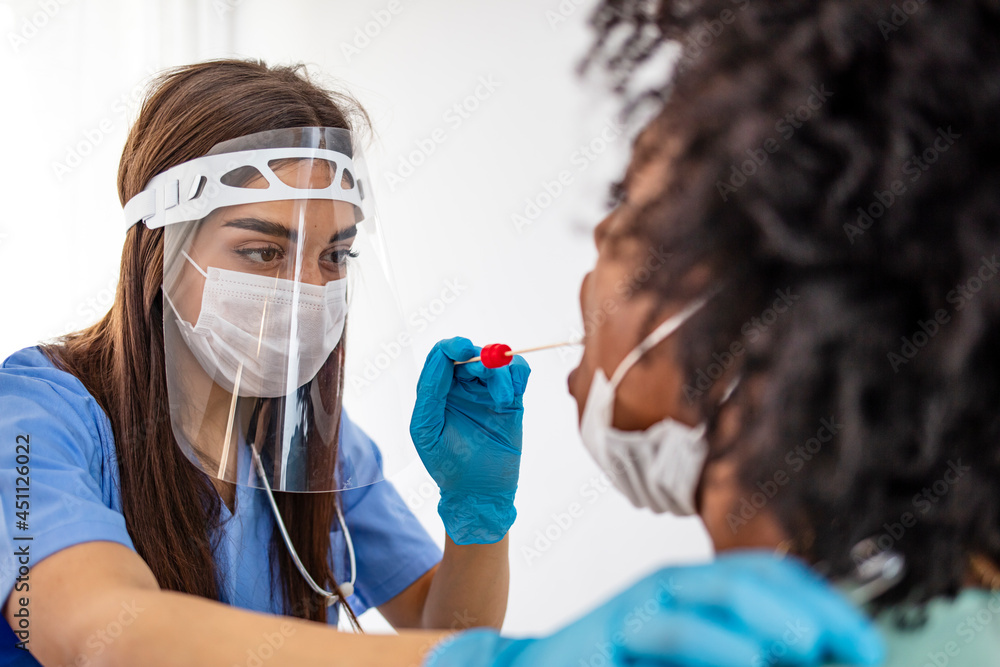 Doctor wearing personal protective equipment performing a Coronavirus ...