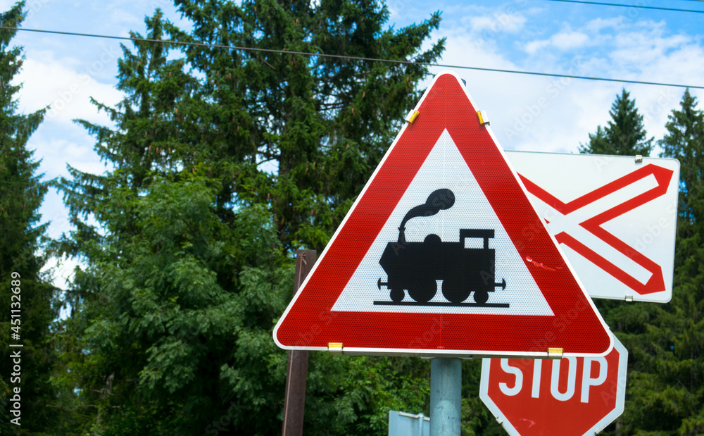 Typical european railroad crossing sign on a country road, pointing to ...