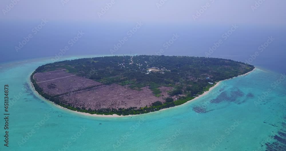 An extreme wide aerial view of a tropical island located on top of a ...
