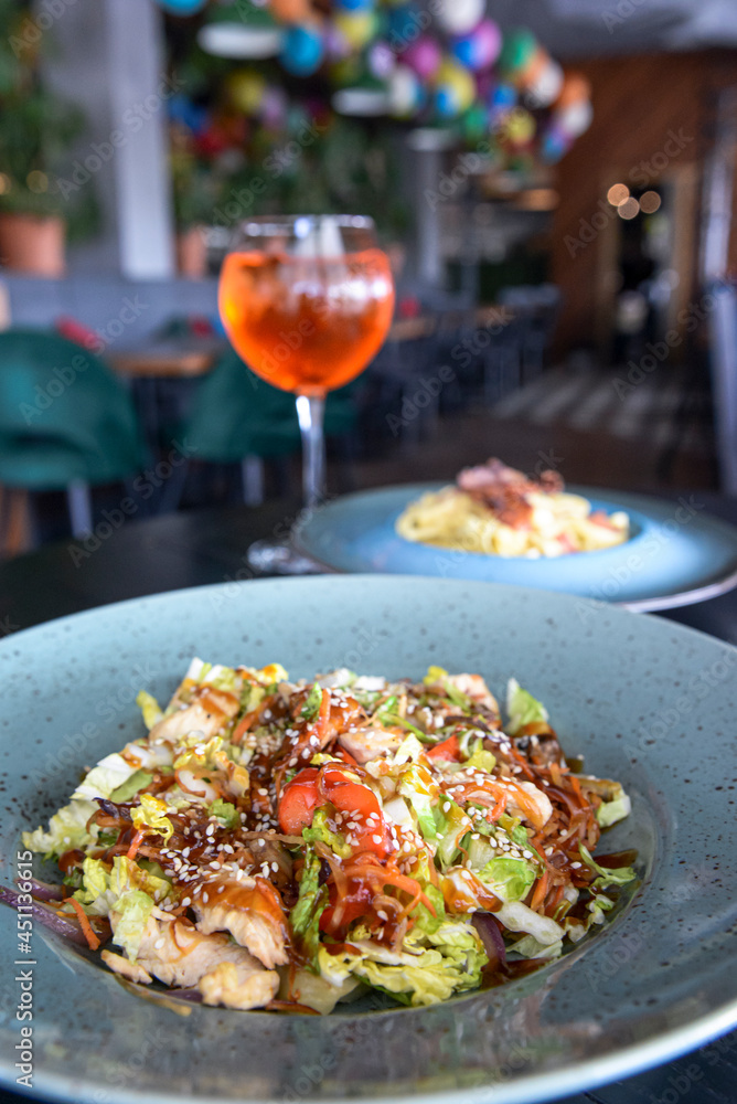 Asian wok stir fry served in a plate over dark wooden table. Asian ...