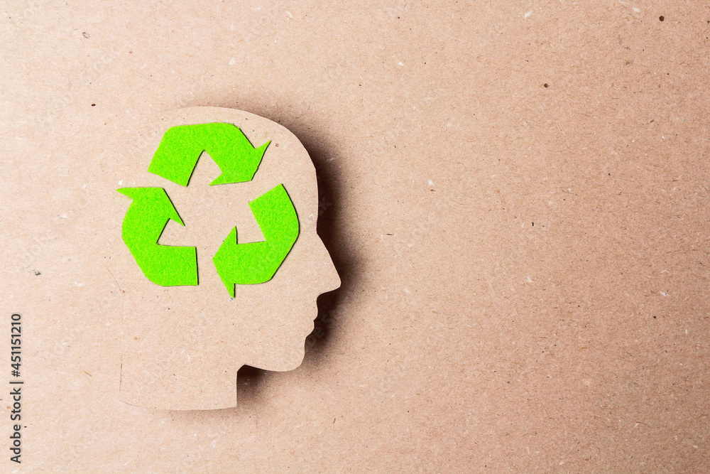 Head profile silhouette with recycle symbol on brown paper background ...