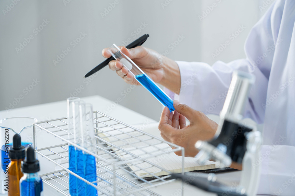 scientists researching in laboratory in white lab coat, gloves ...