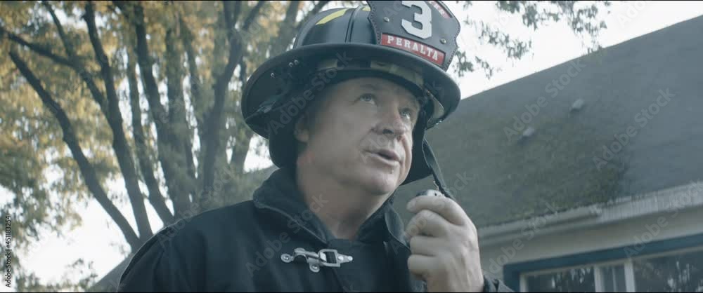 Firefighter chief talking on CB radio and giving orders to his crew ...